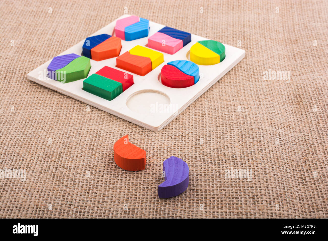 Colorful wooden pieces of a logic puzzle Stock Photo - Alamy