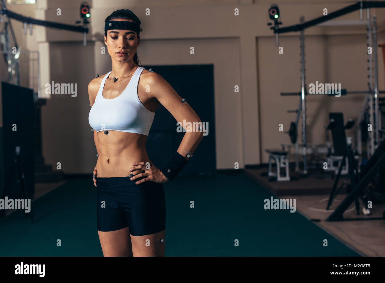 Female athlete with motion capture sensors on her body to record the ...