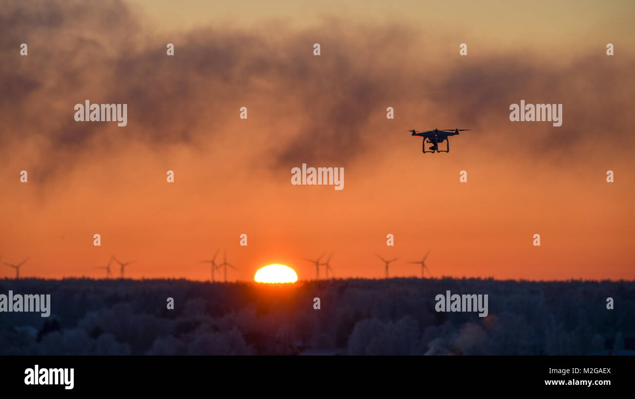 Drone flying in the sunset Stock Photo - Alamy