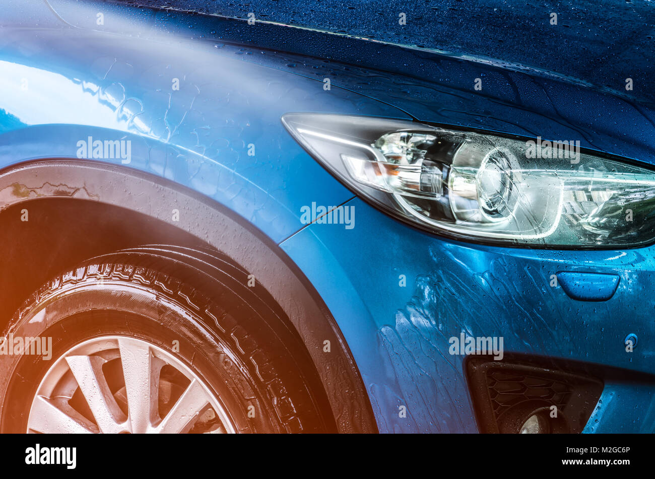 Blue compact SUV car with sport and modern design are washing with ...