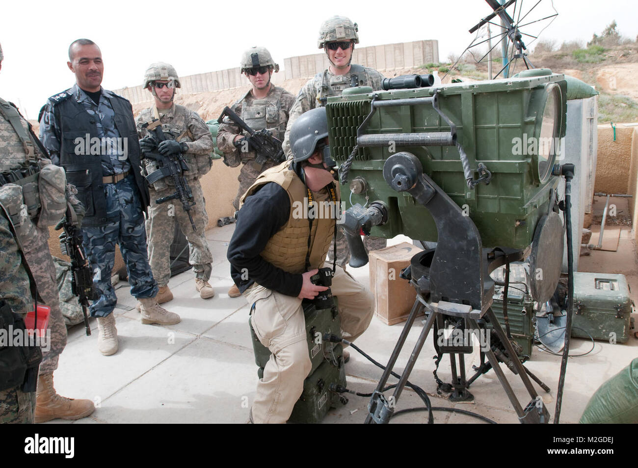 A Stars and Stripes journalist looks through a Forward Looking Infrared ...