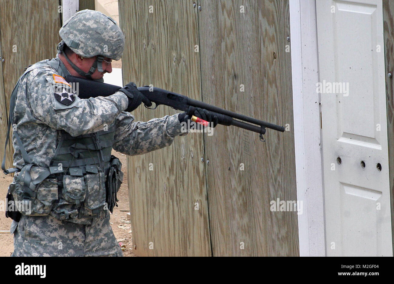 An ADLC student uses a shotgun to breach a closed, lock door by Georgia ...