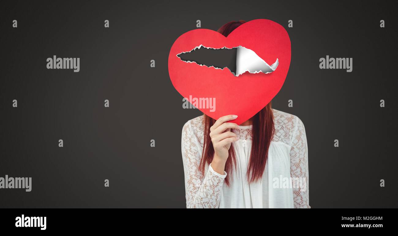 Woman holding hurt love heart with torn paper Stock Photo - Alamy