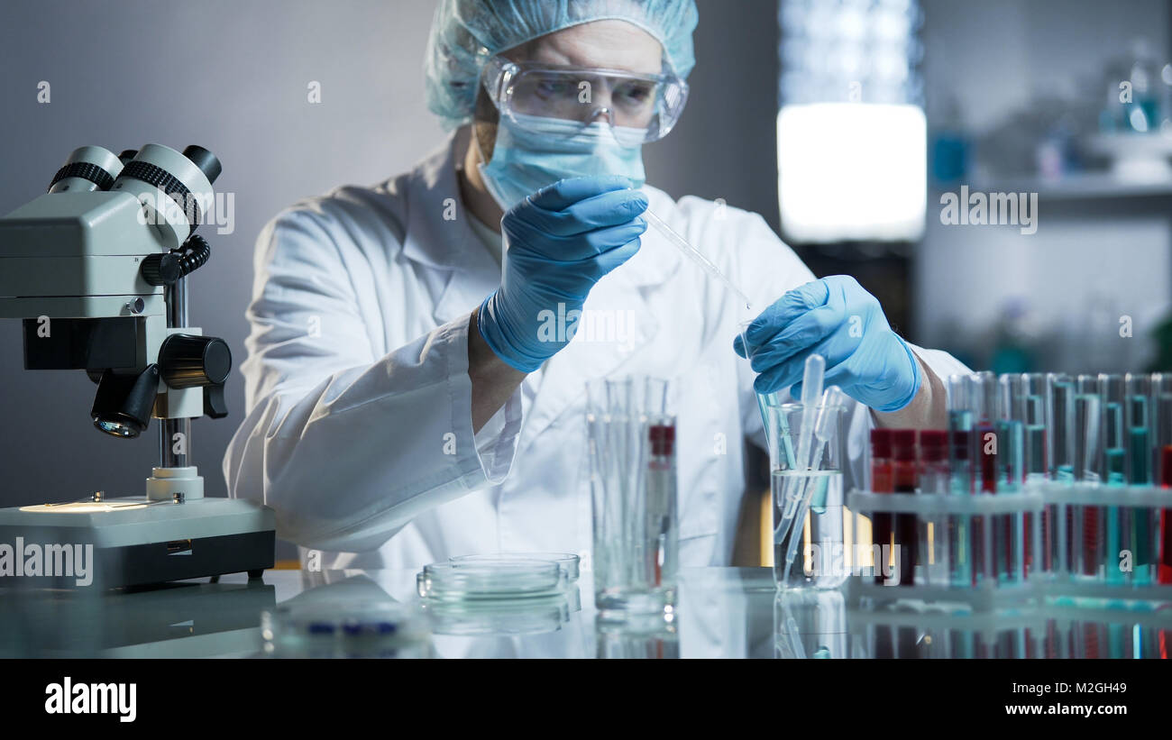 Laboratory worker measuring exact formula for hypoallergenic cosmetic ...