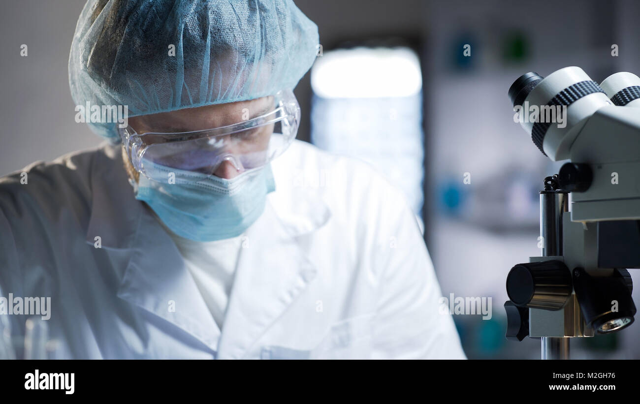 Male medical analyst nervously waiting for results of his scientific ...