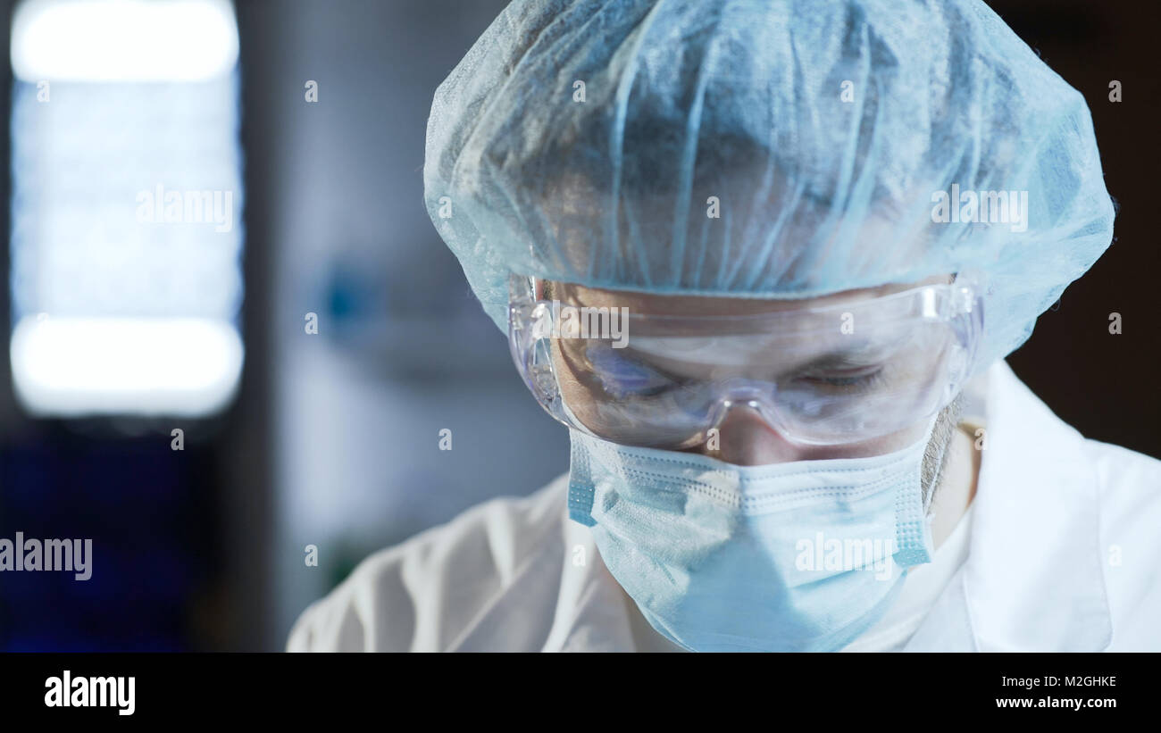 Surgeon assistant preparing patient and medical equipment for operation ...