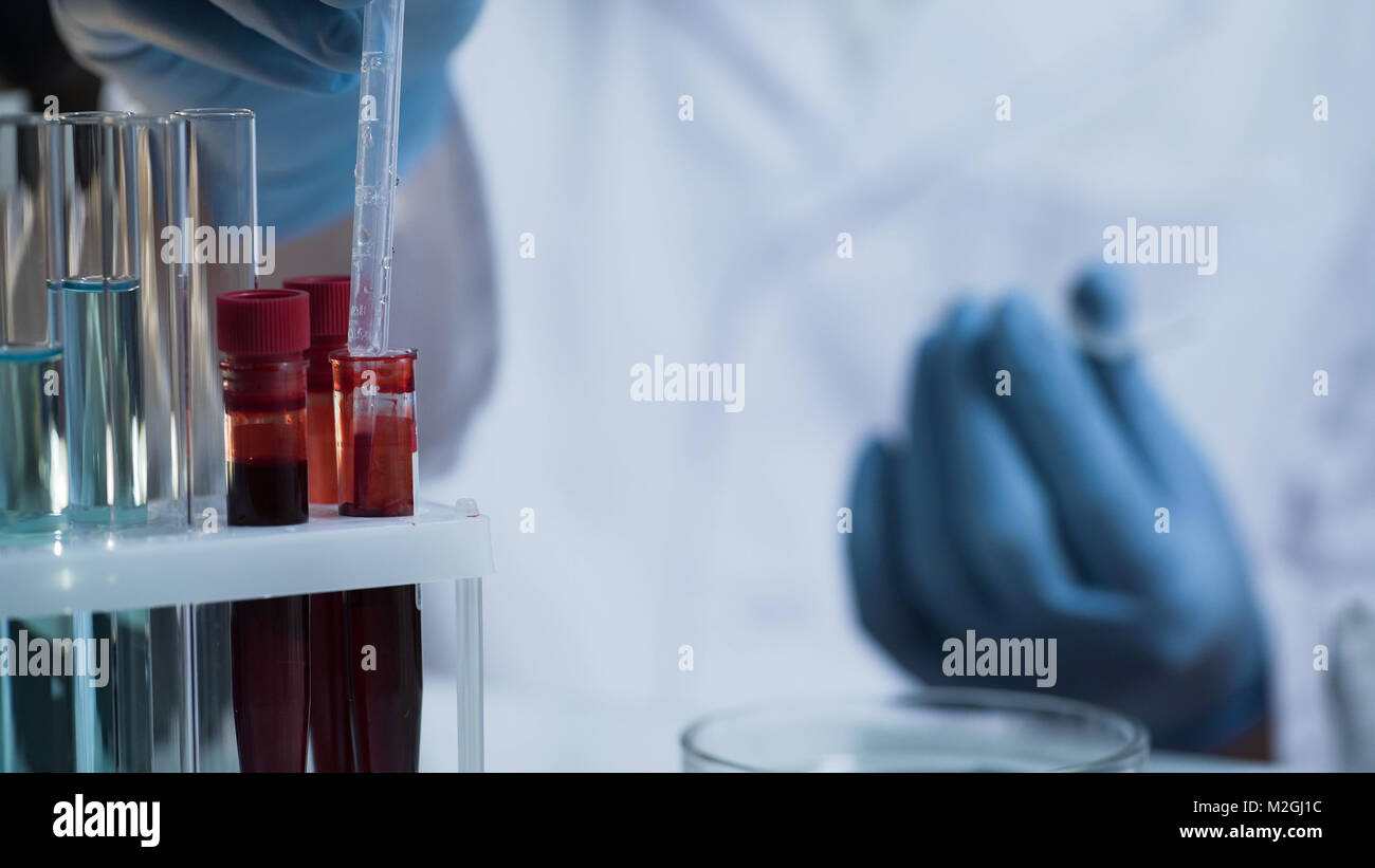 Scientist taking blood drop for medical research, creating vaccine ...