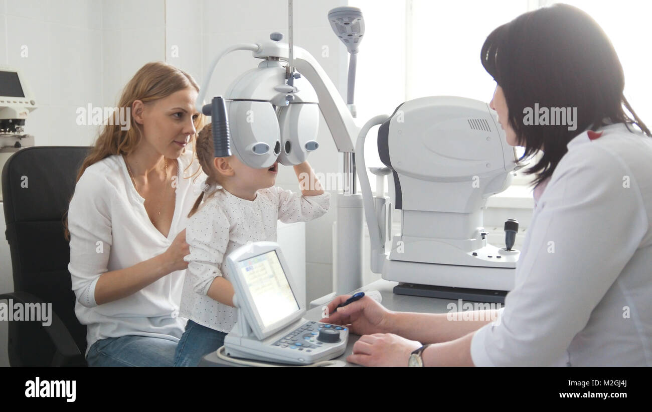 Children ophthalmology - optometrist Checks Eye of little girl Stock ...
