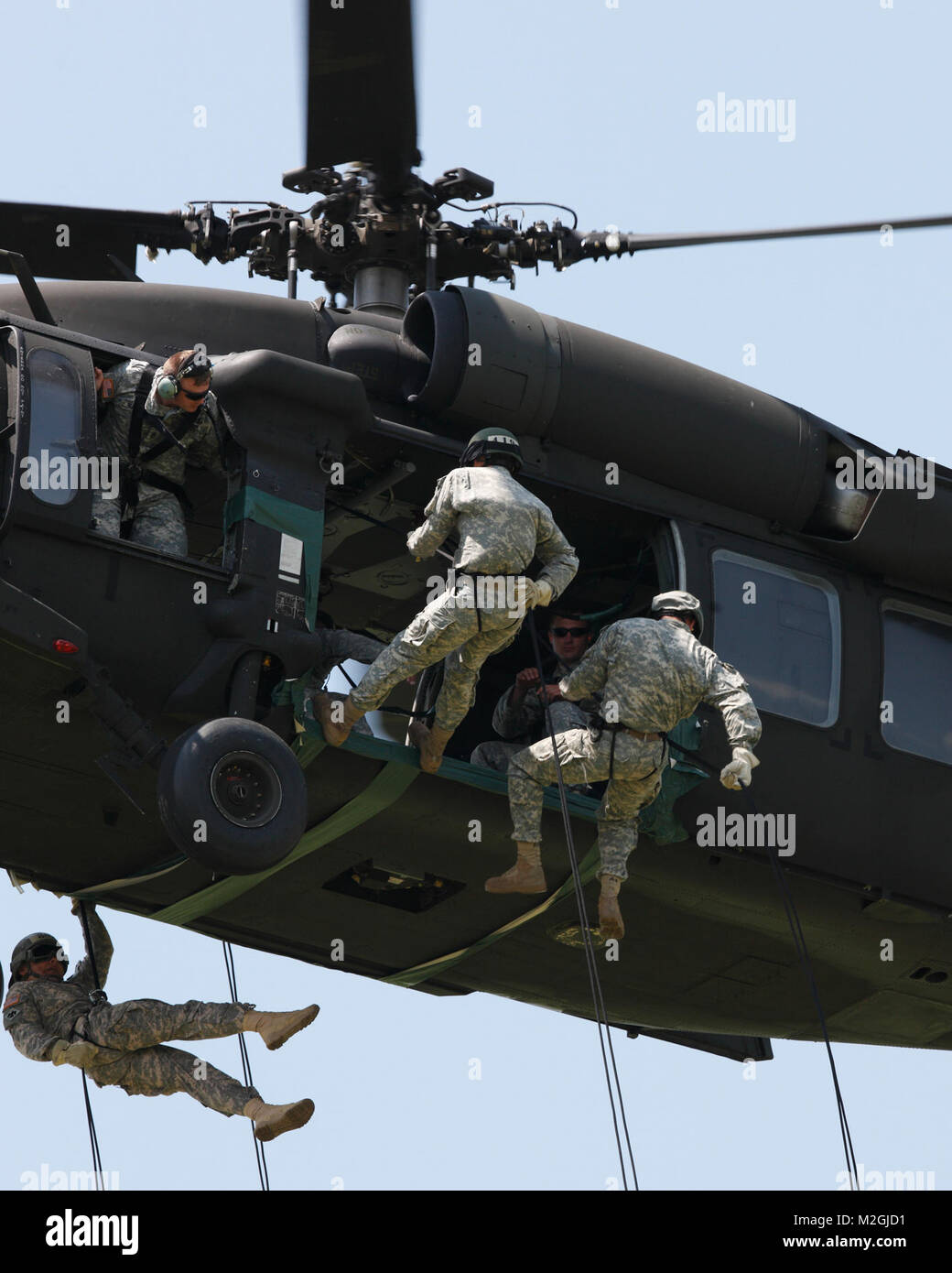 Students in the Army Air Assault School repel from a UH-60 helicopter ...