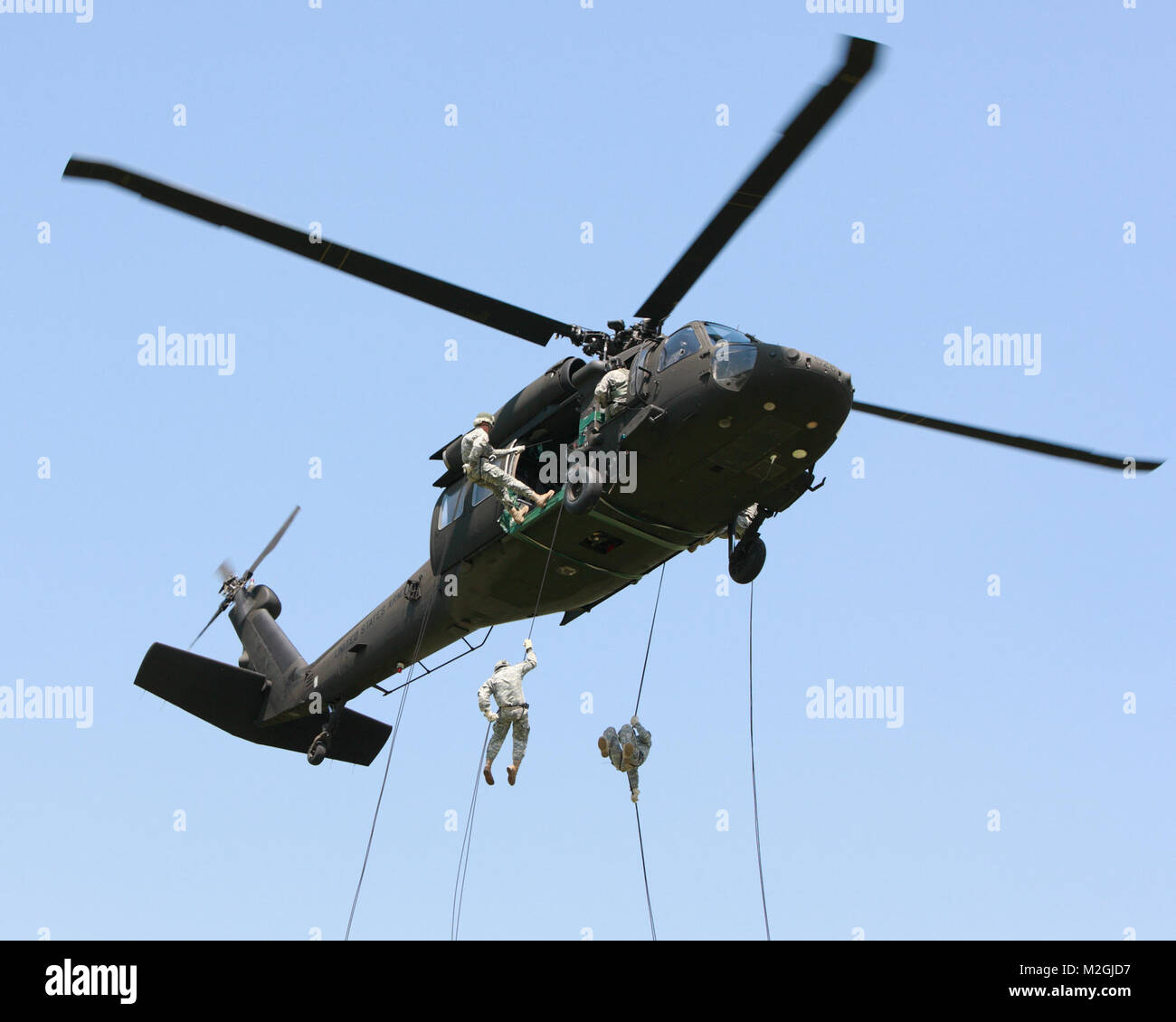 Students in the Army Air Assault School repel from a UH-60 helicopter ...