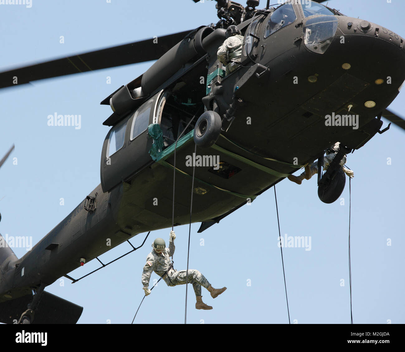 Students in the Army Air Assault School repel from a UH-60 helicopter ...