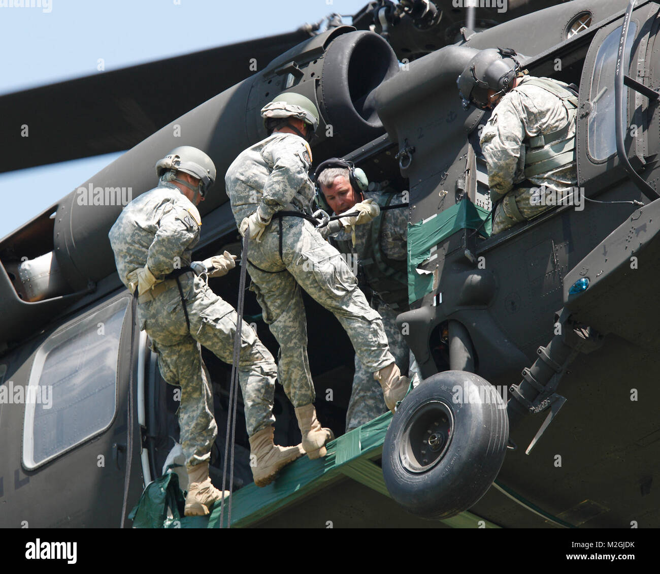 Students in the Army Air Assault School repel from a UH-60 helicopter ...