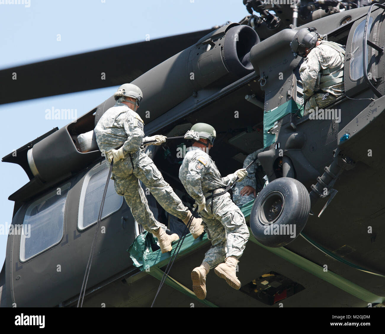 Students in the Army Air Assault School repel from a UH-60 helicopter ...