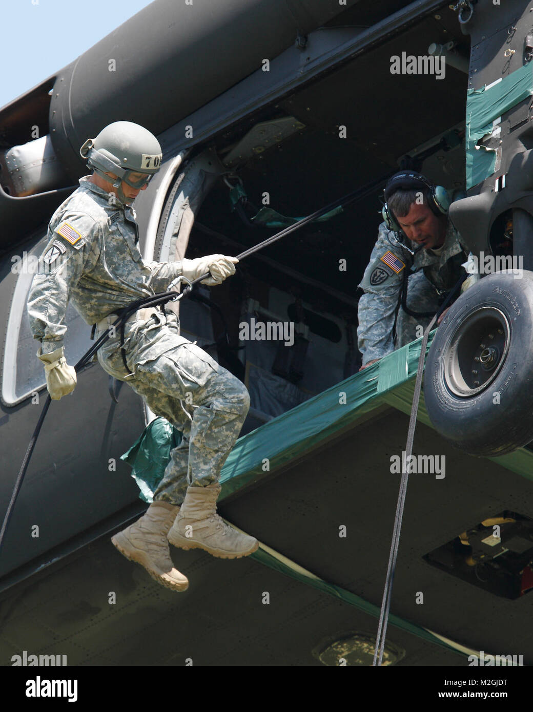 Students in the Army Air Assault School repel from a UH-60 helicopter ...