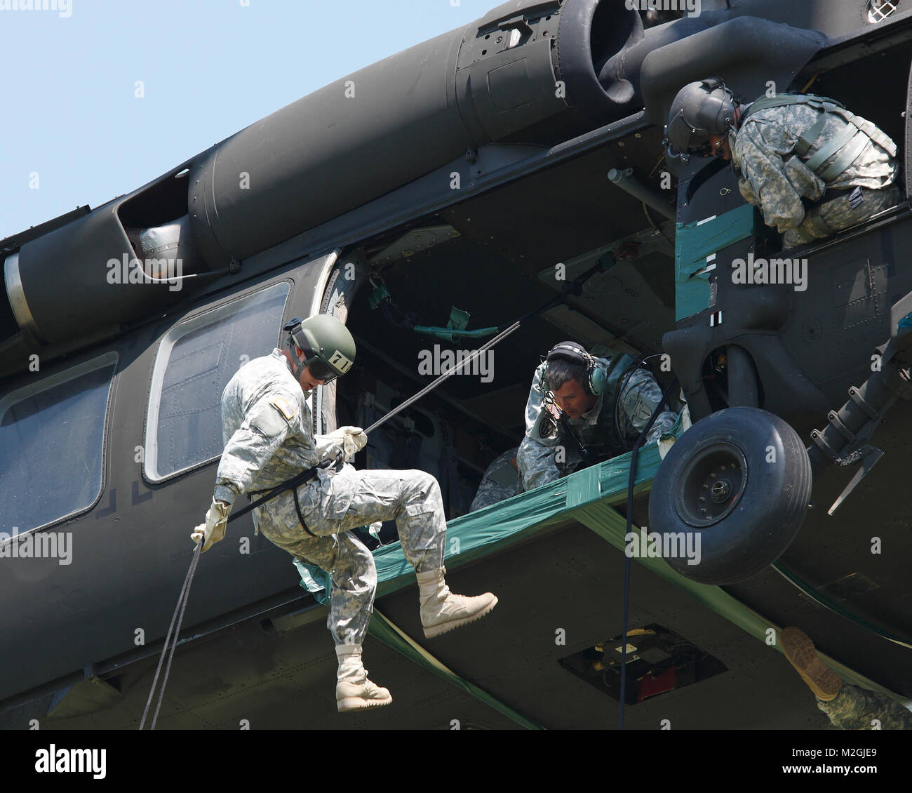 Students in the Army Air Assault School repel from a UH-60 helicopter ...