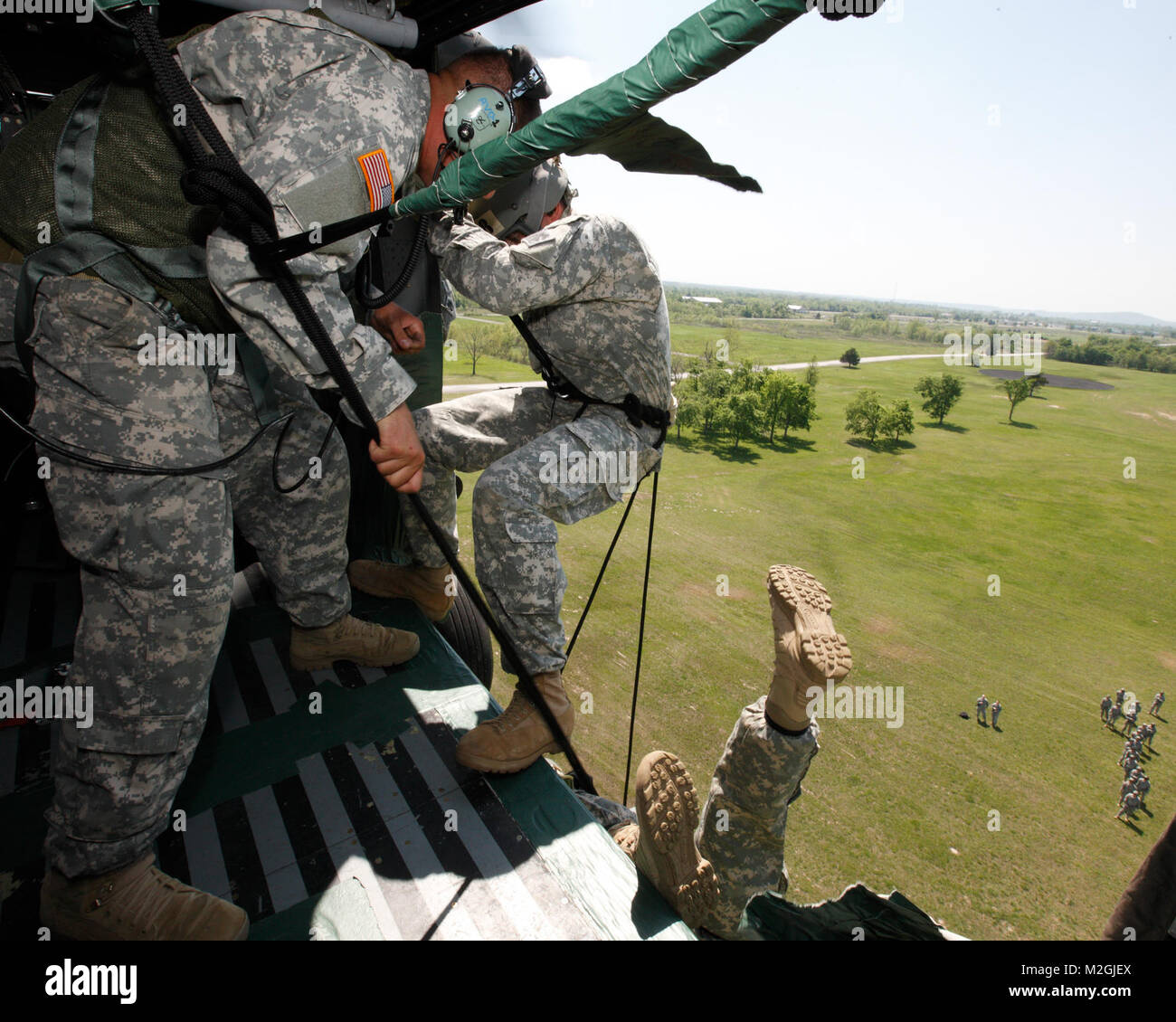 Students in the Army Air Assault School repel from a UH-60 helicopter ...