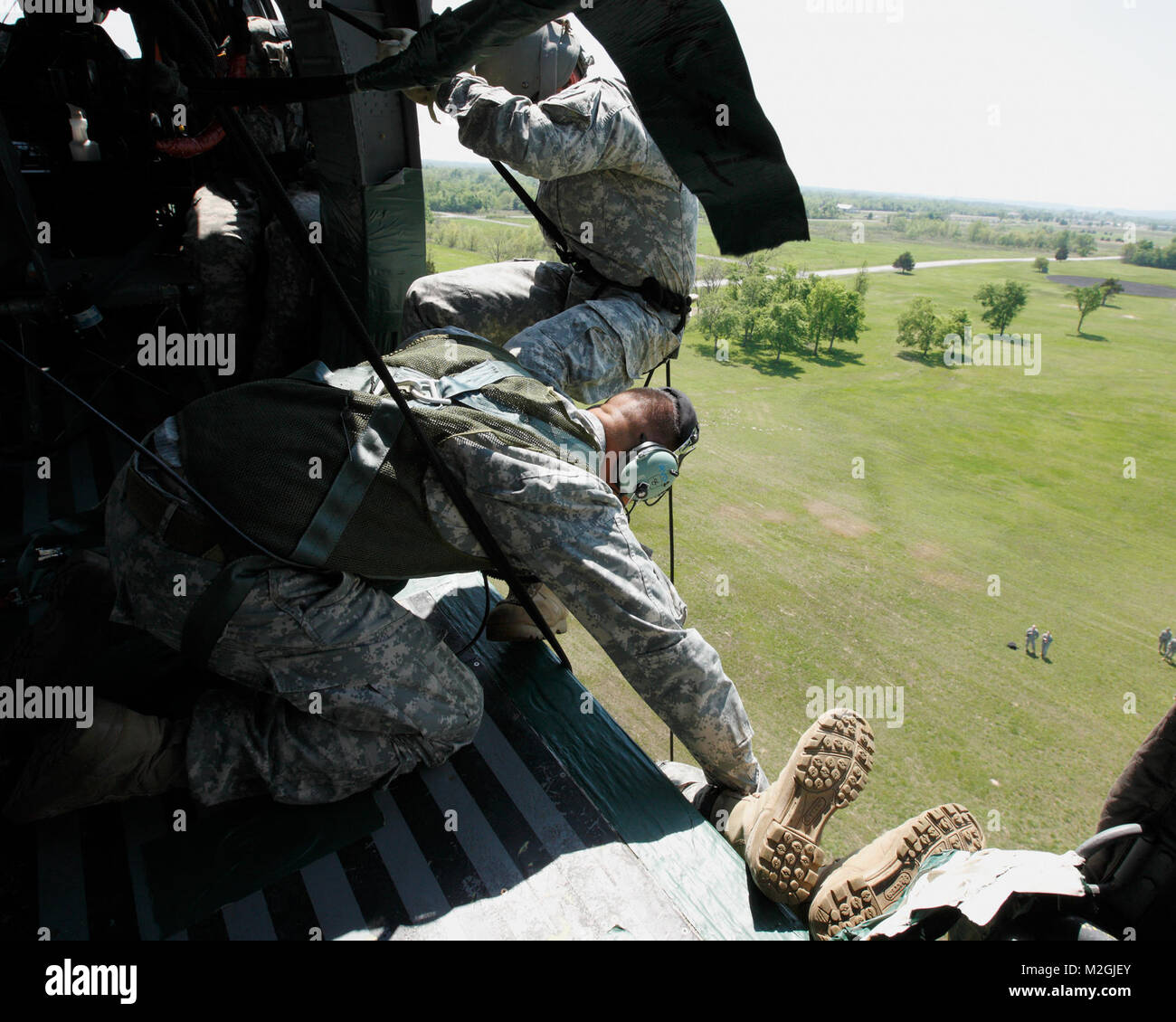 Students in the Army Air Assault School repel from a UH-60 helicopter ...