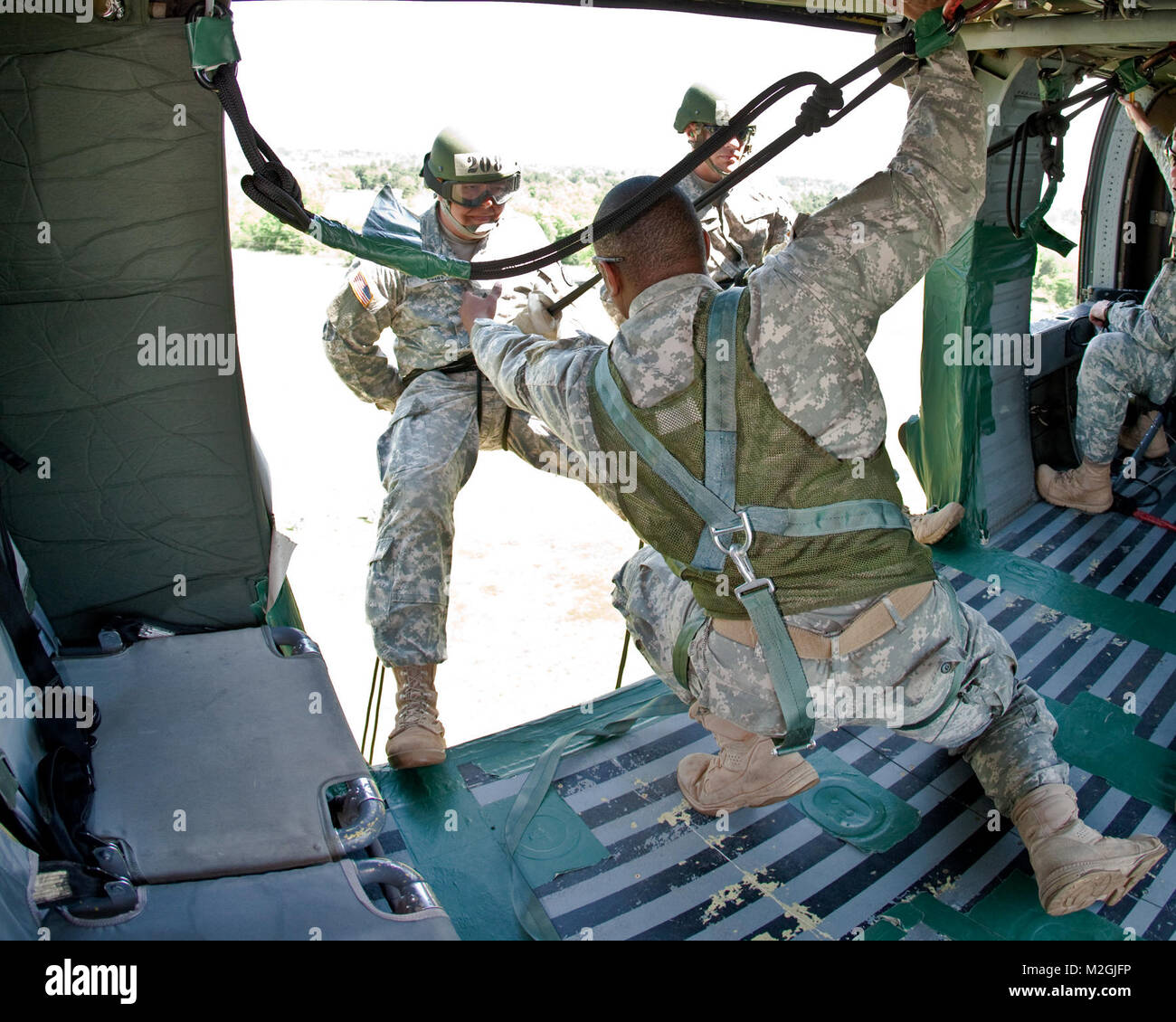 Students in the Army Air Assault School repel from a UH-60 helicopter ...