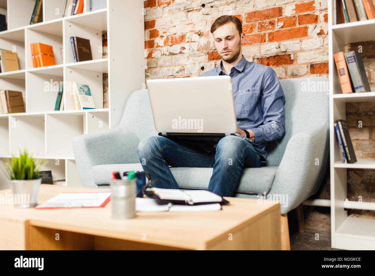 Young man with a laptop Stock Photo - Alamy