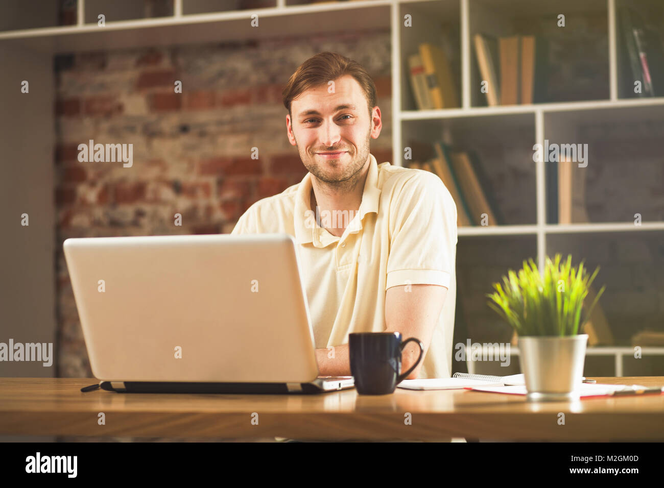 Young man with a laptop Stock Photo - Alamy