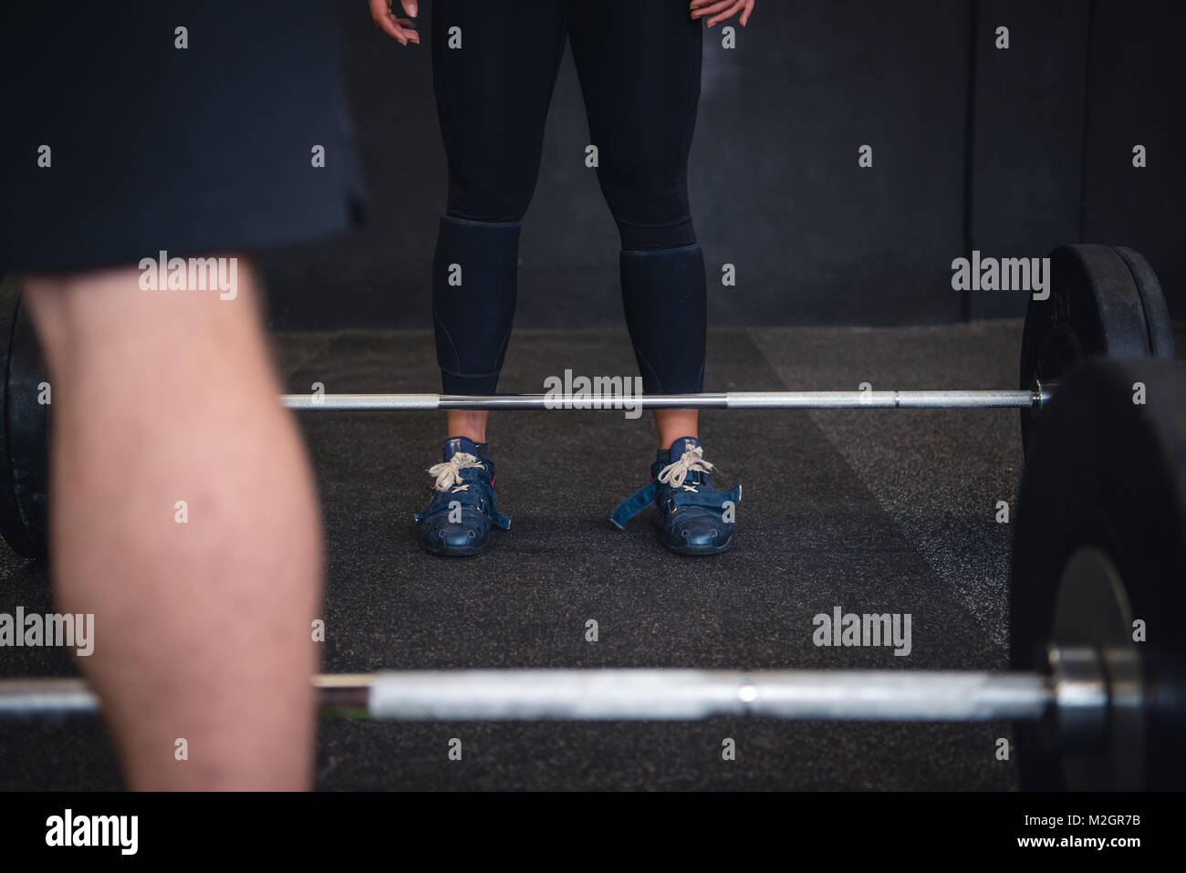 Weightlifting, powerlifting, crossfit man and woman working out in gym ...