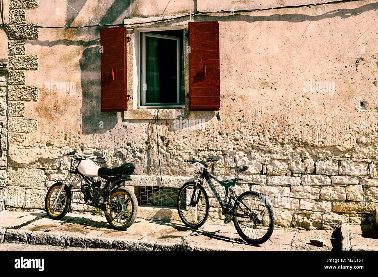 Two bikes against the wall Stock Photo - Alamy