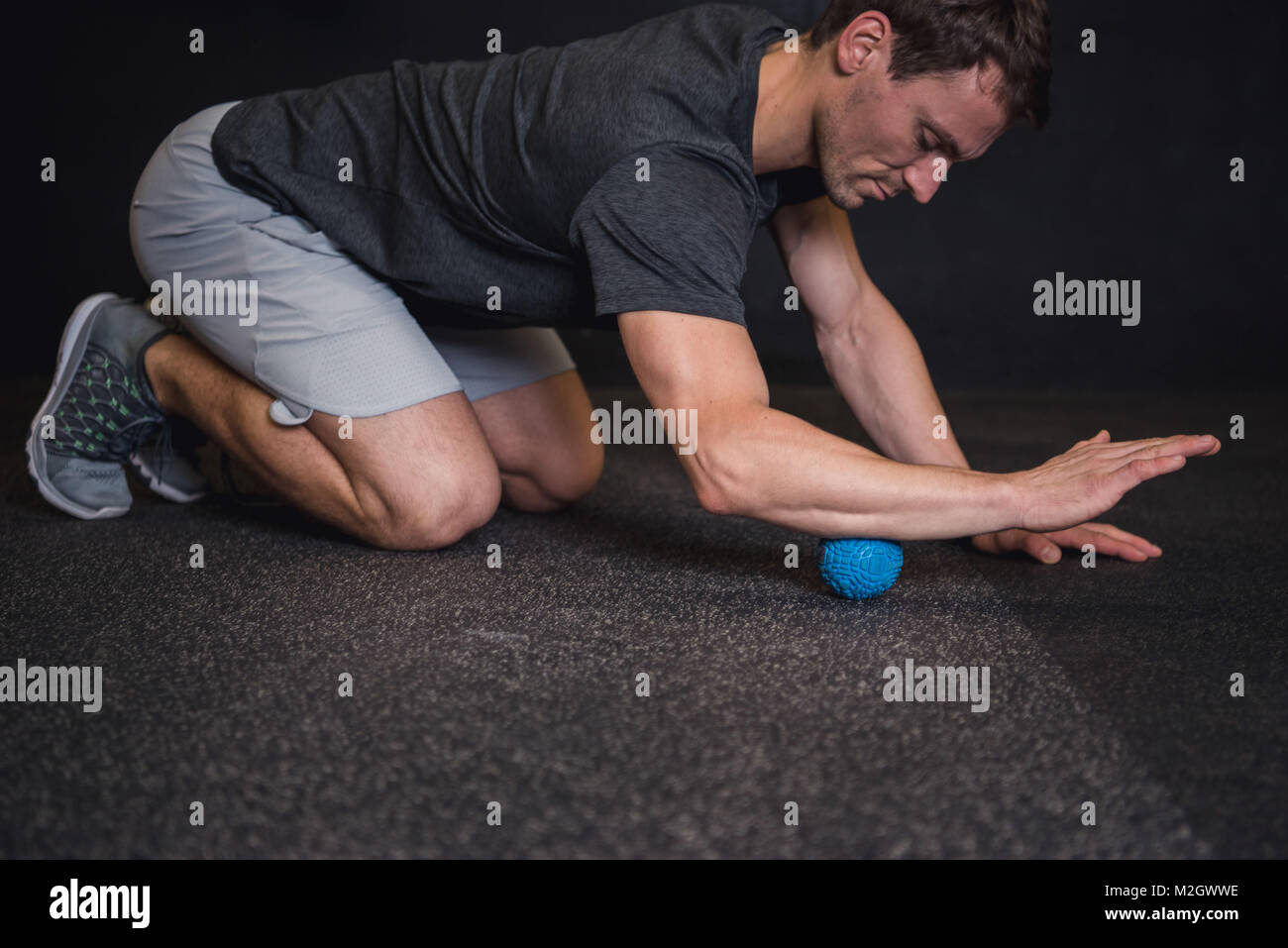 Caucasian man in his 30s stretching and rolling out muscles after ...