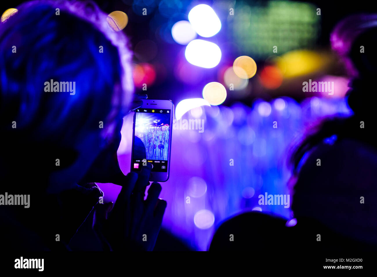 A woman takes an photo on her iPhone of Entre les rangs by Rami Bebawi ...
