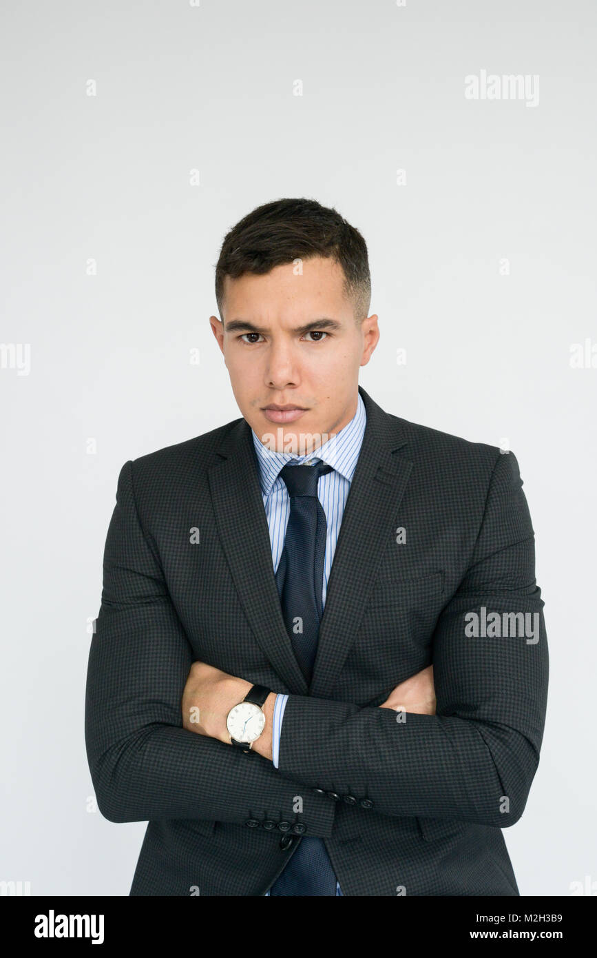 Portrait of an unhappy, grumpy handsome young man looking into camera ...