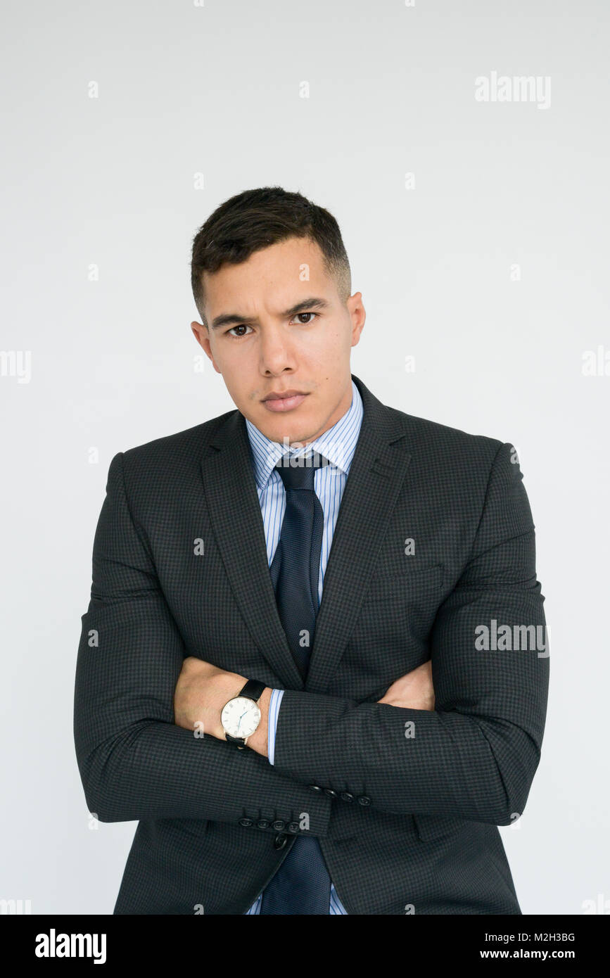 Portrait of an unhappy, grumpy handsome young man looking into camera ...