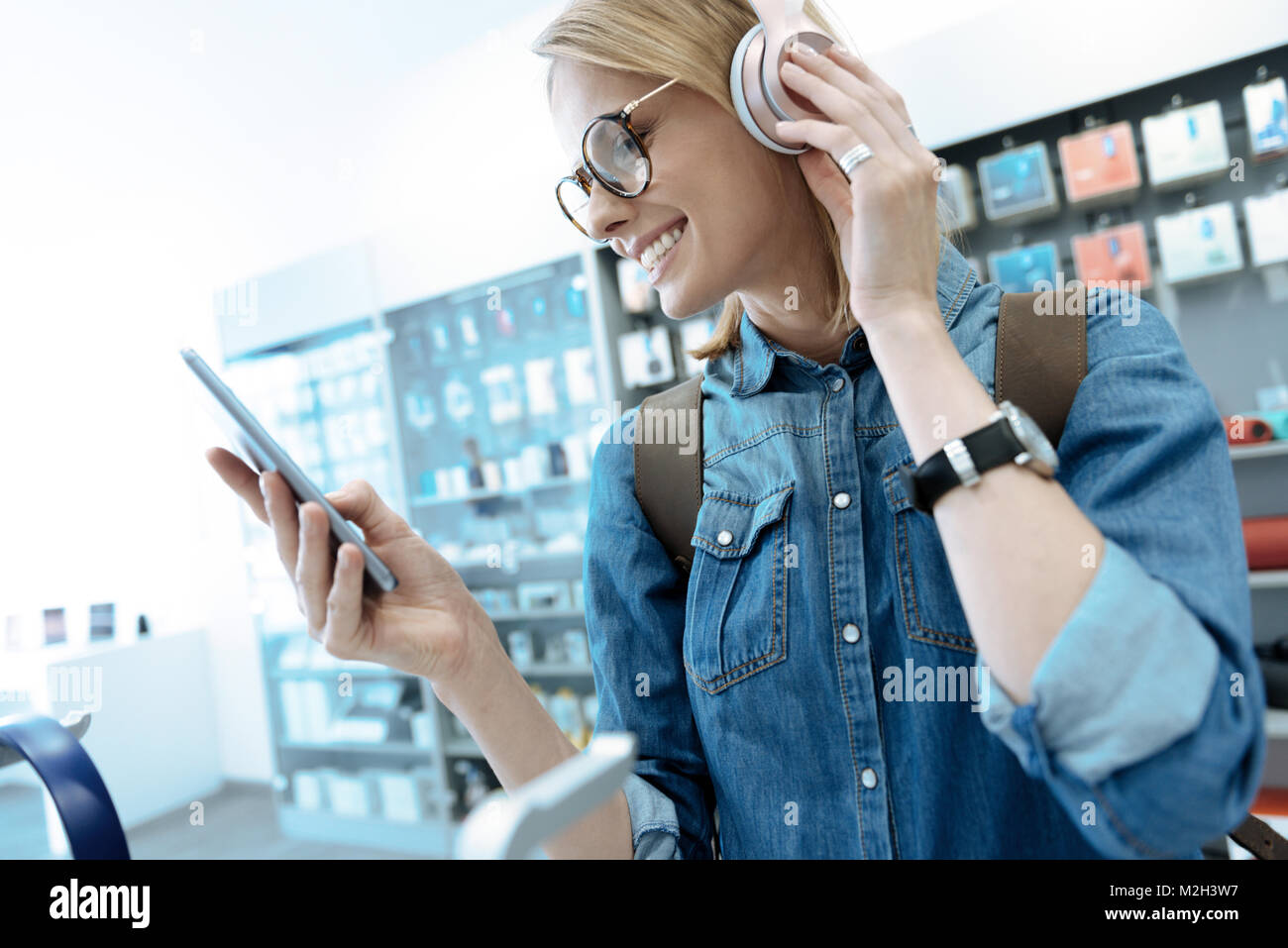 Positive delighted female searching necessary song Stock Photo - Alamy Positive delighted female searching necessary song Stock Photo - Alamy