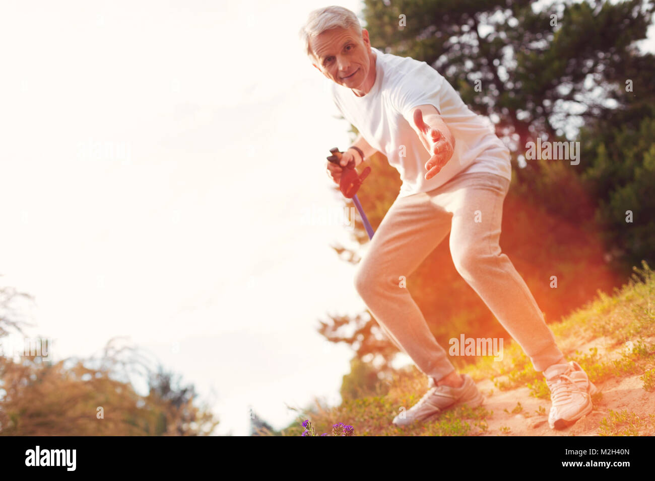 Full length of elderly man putting his hand forward Stock Photo - Alamy