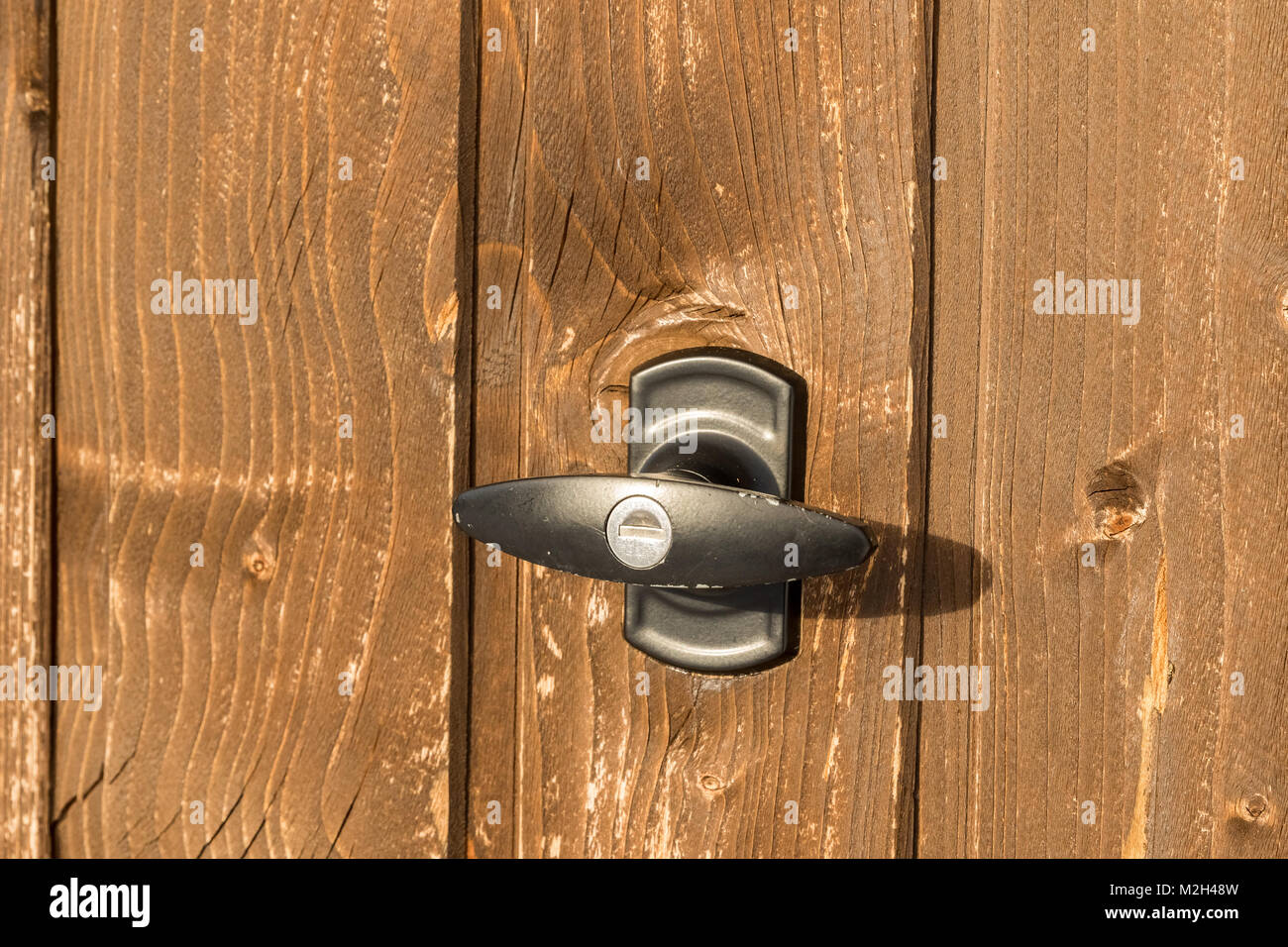 Garage handle on a brown garage door Stock Photo - Alamy