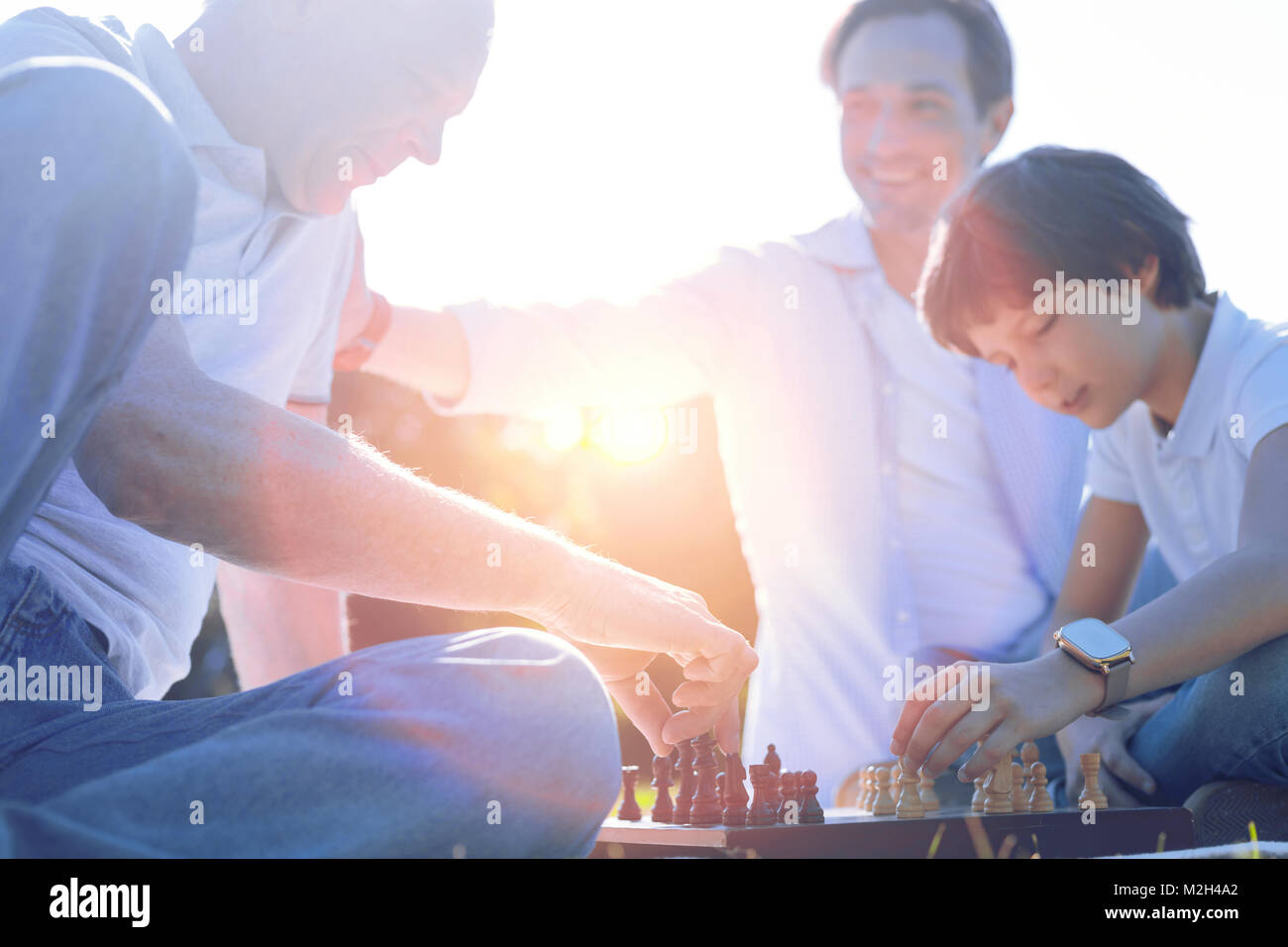 Friendly family playing chess together Stock Photo - Alamy