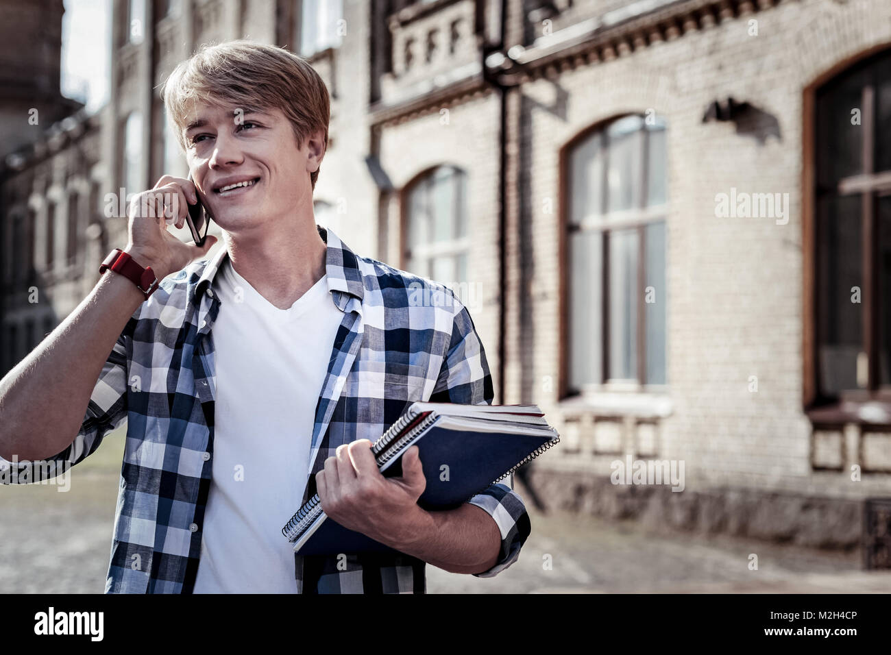 Nice happy student talking on the phone Stock Photo - Alamy