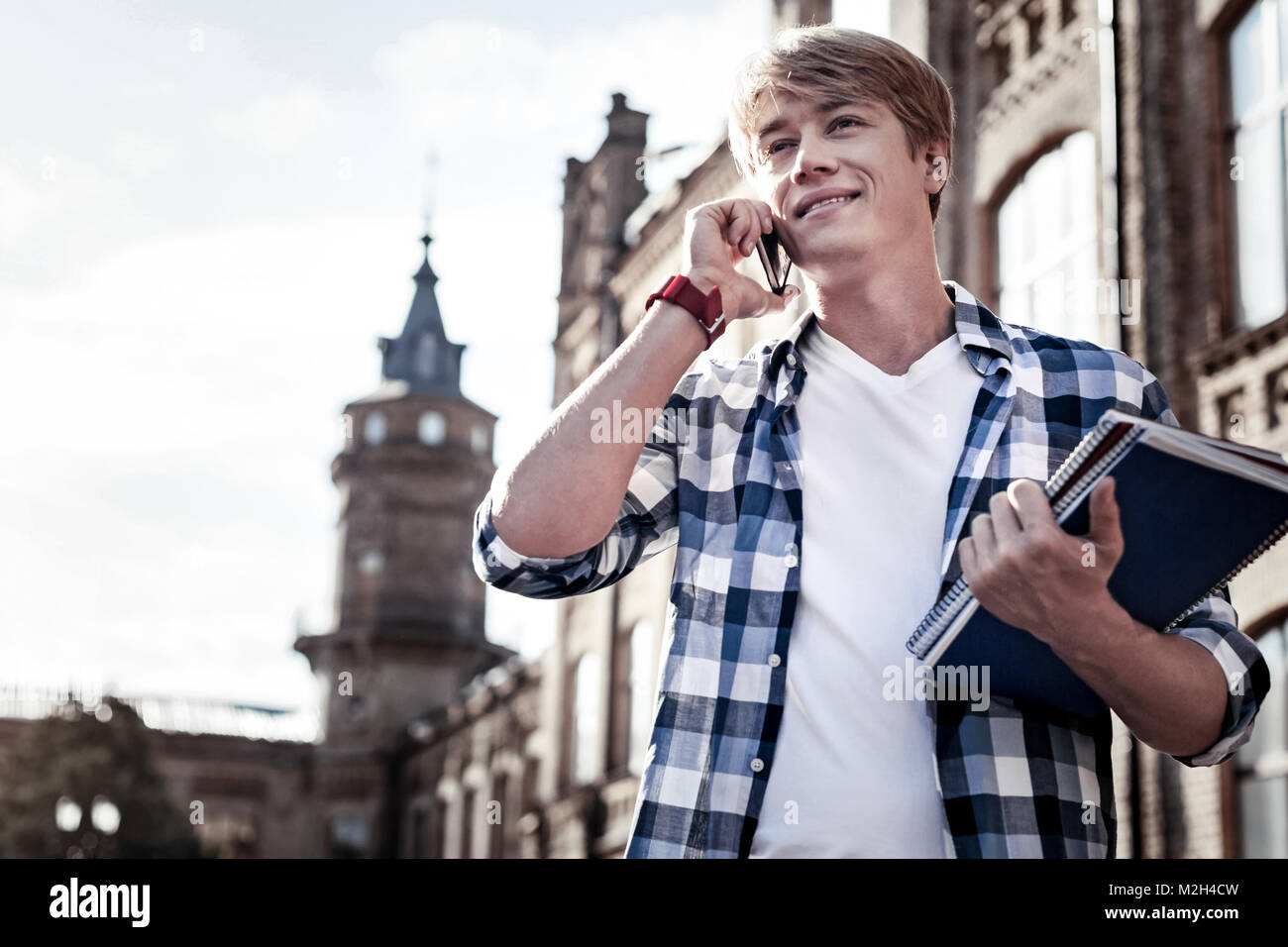 Nice positive man making a call Stock Photo - Alamy