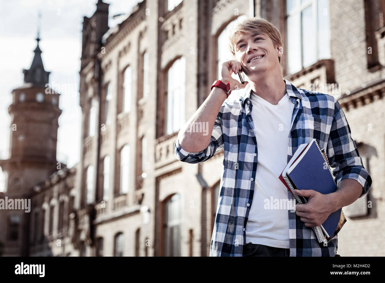 Joyful positive student sharing news Stock Photo - Alamy