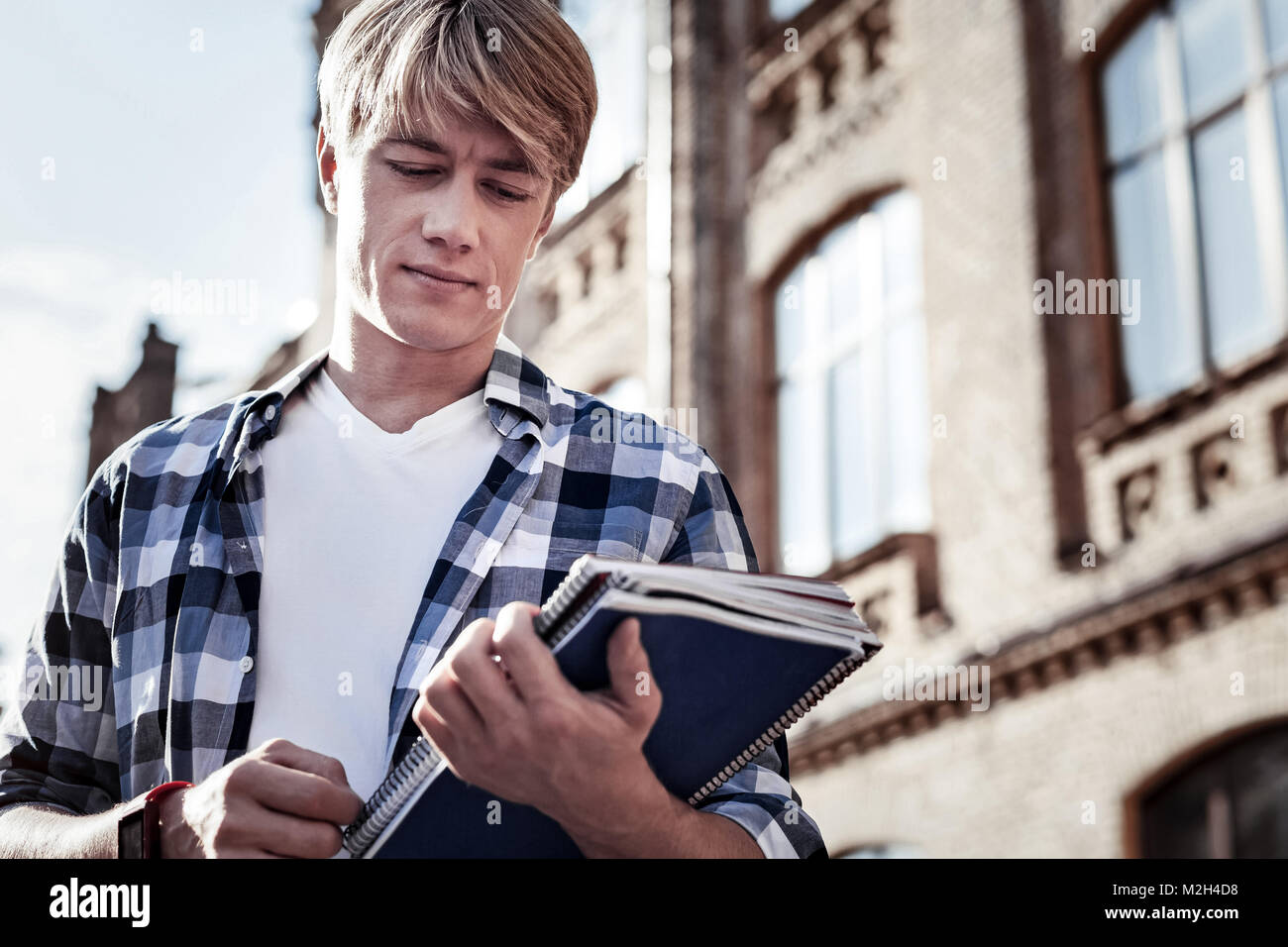 Nice serious man looking at his books Stock Photo - Alamy