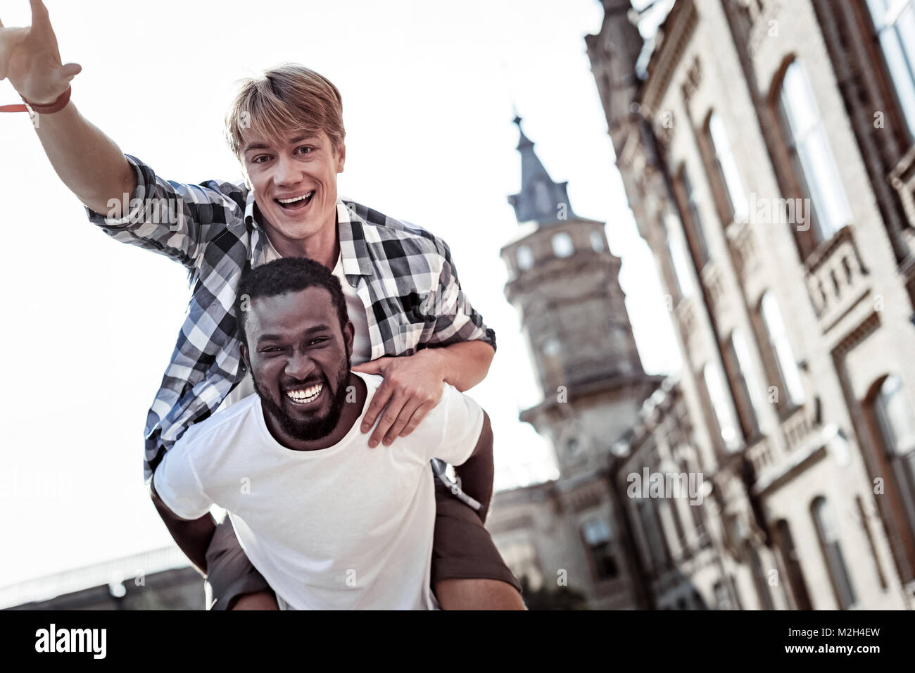 Joyful positive man having fun with his friend Stock Photo - Alamy