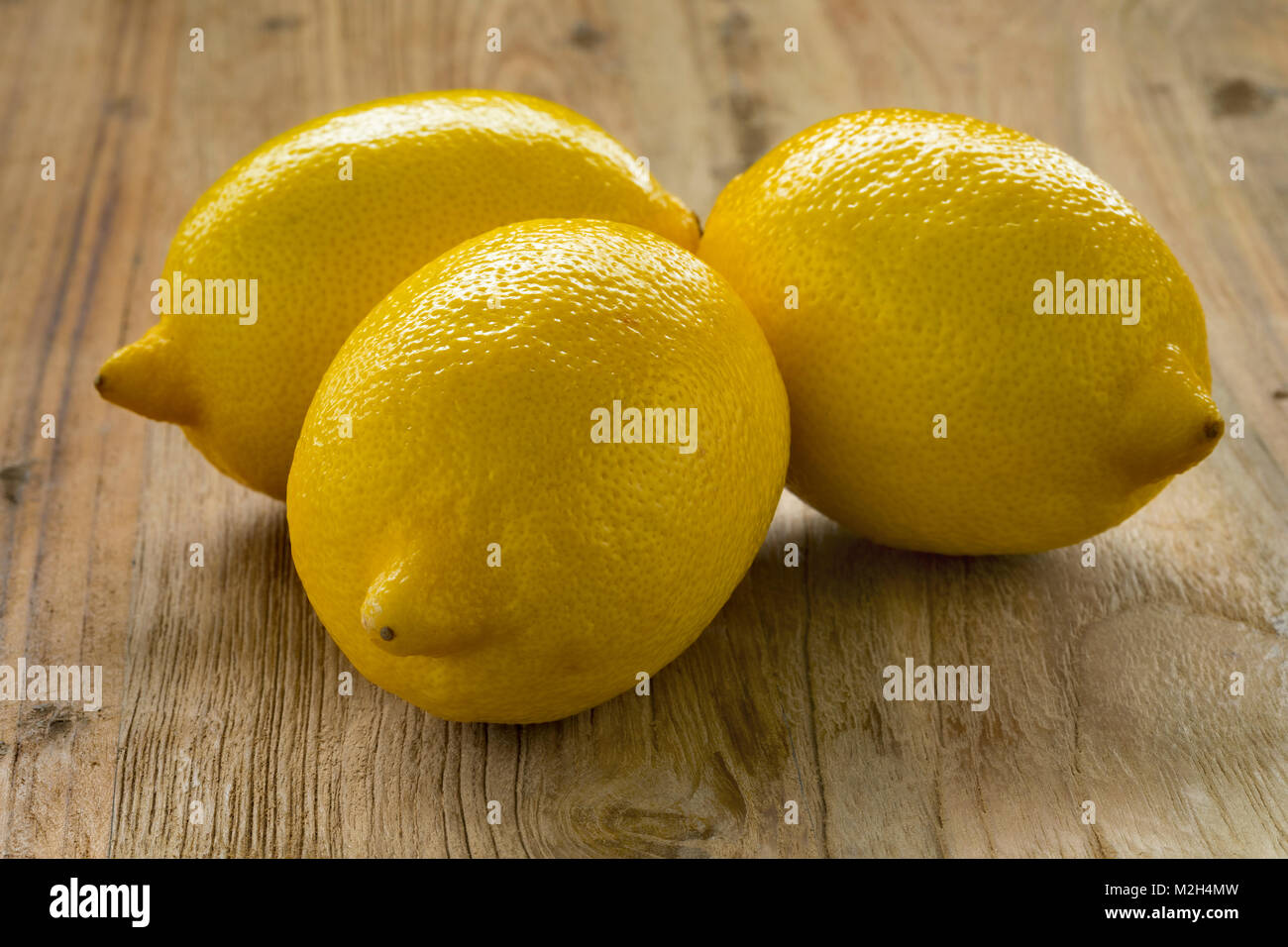 Three whole fresh yellow lemons Stock Photo - Alamy