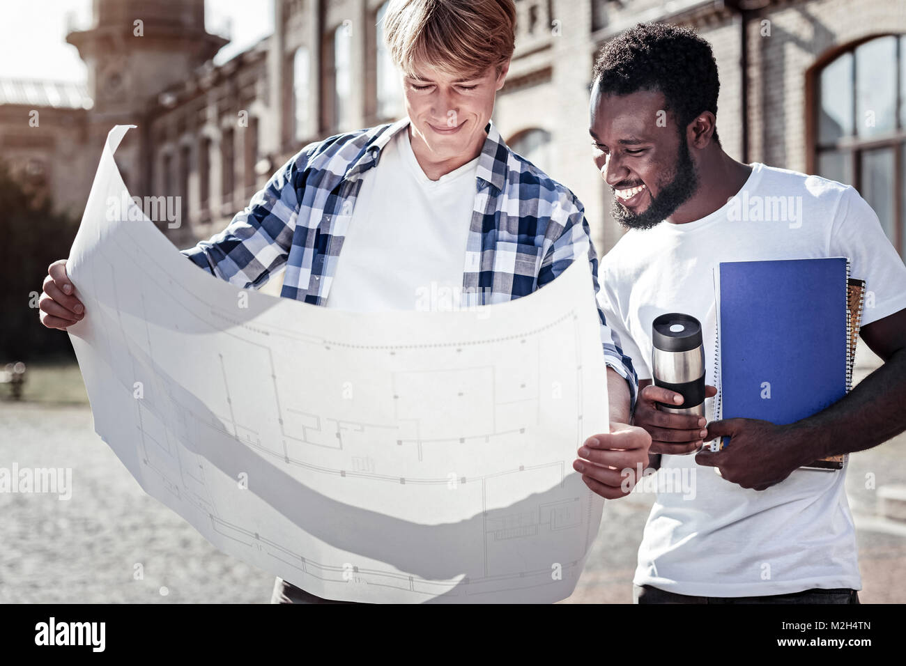 Nice smart students studying the blueprint Stock Photo - Alamy
