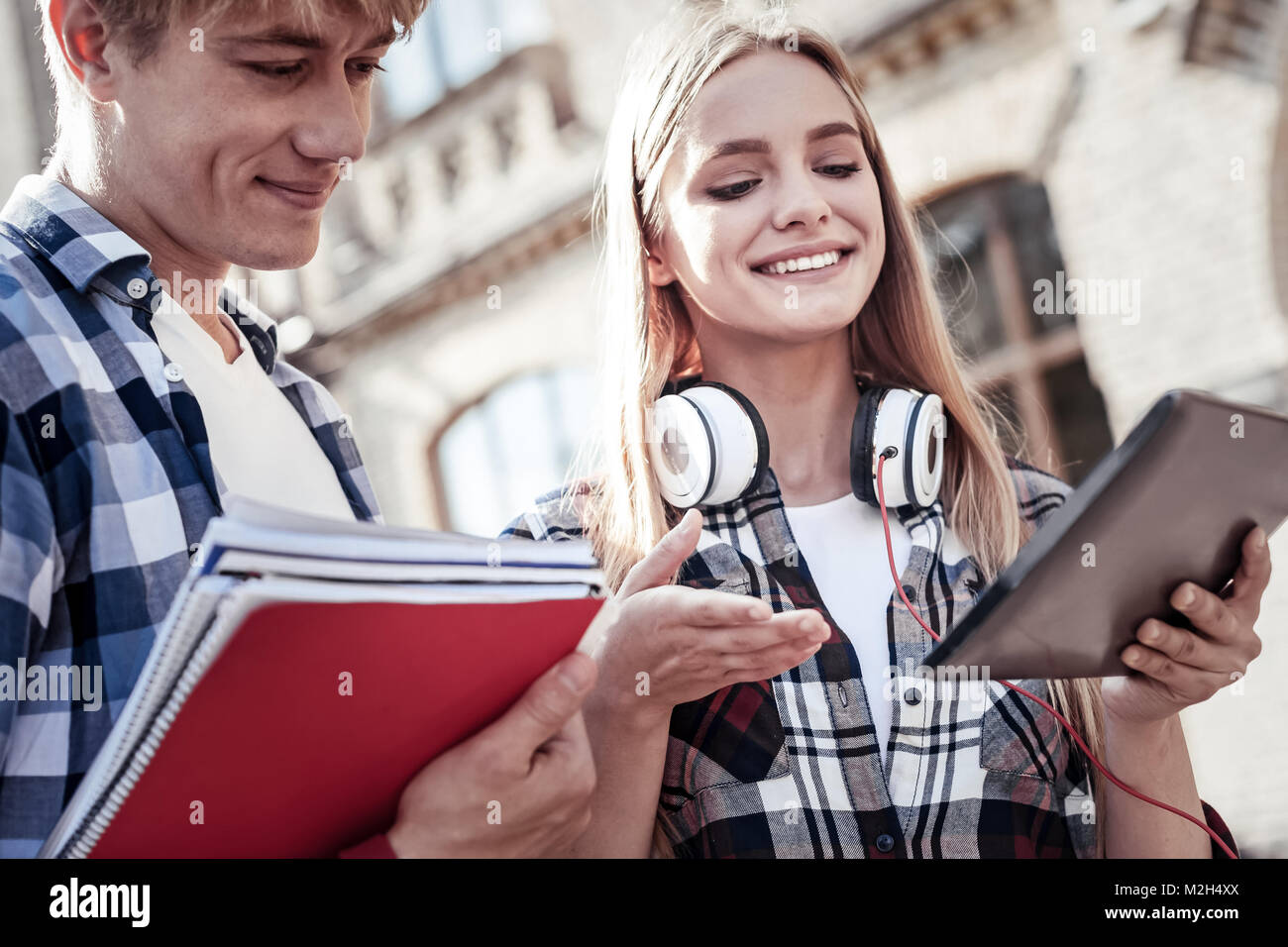 Joyful positive students talking to each other Stock Photo - Alamy