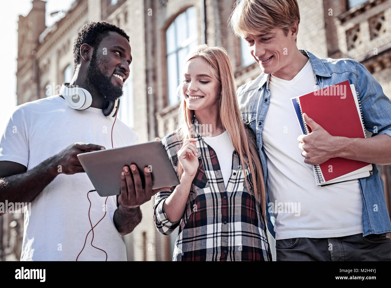 Joyful positive students standing together Stock Photo - Alamy