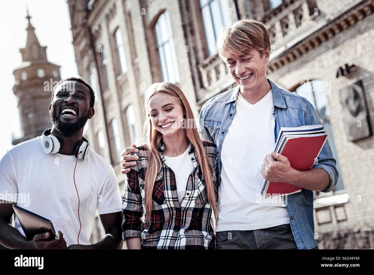 Happy joyful students laughing Stock Photo - Alamy