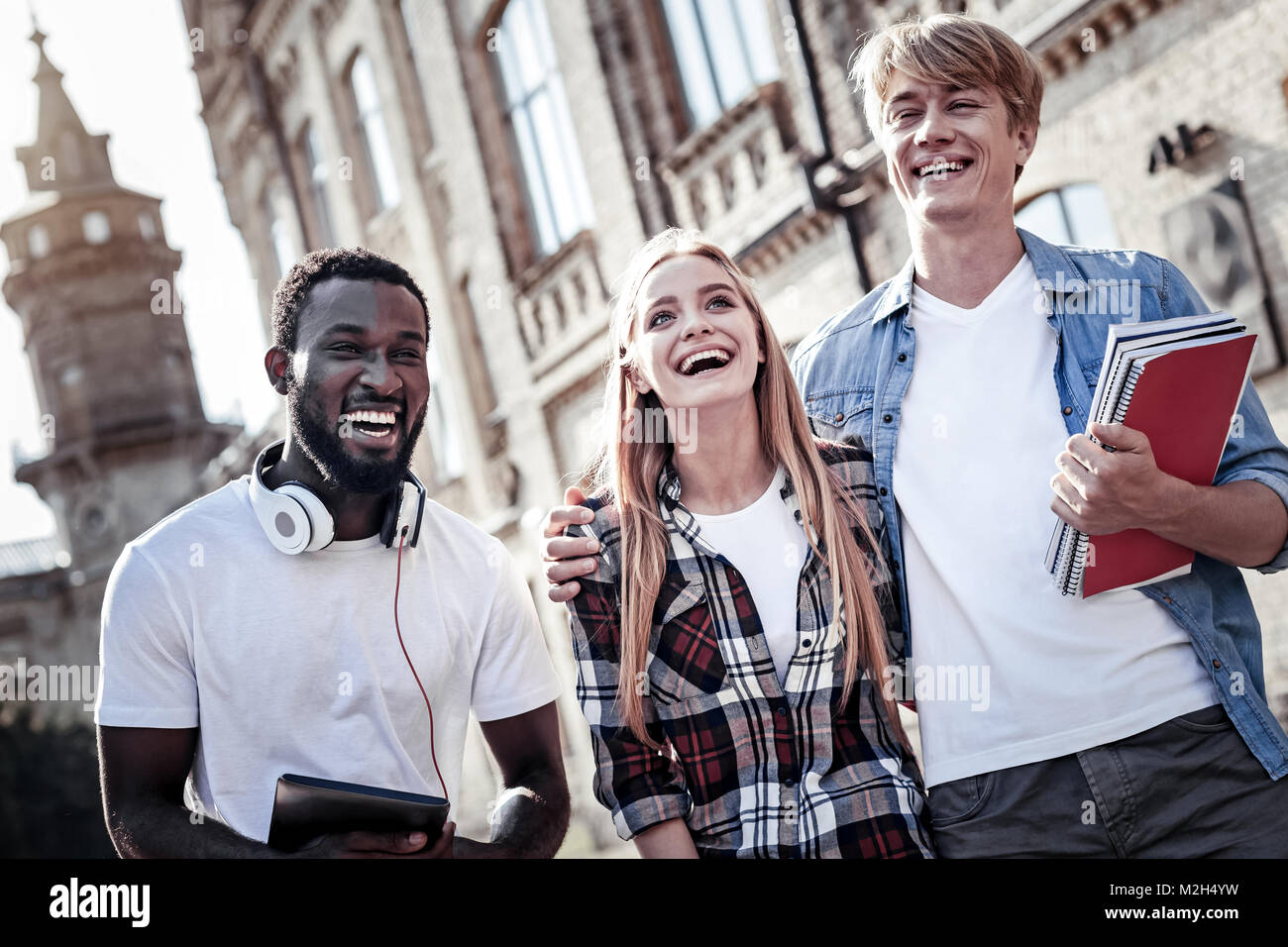 Positive delighted students having fun Stock Photo - Alamy
