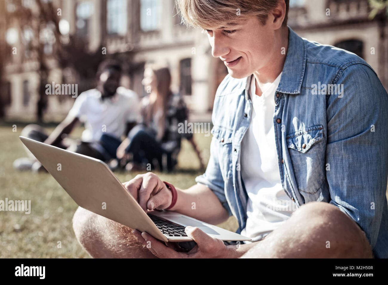 Joyful nice man pressing a button Stock Photo - Alamy