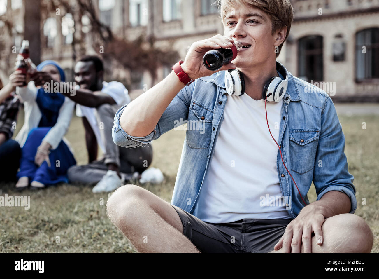 Nice young man drinking coke Stock Photo - Alamy