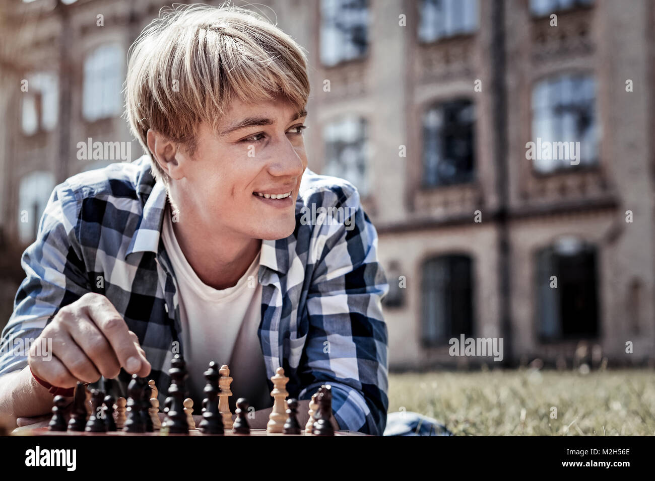 Smart positive man playing chess Stock Photo - Alamy