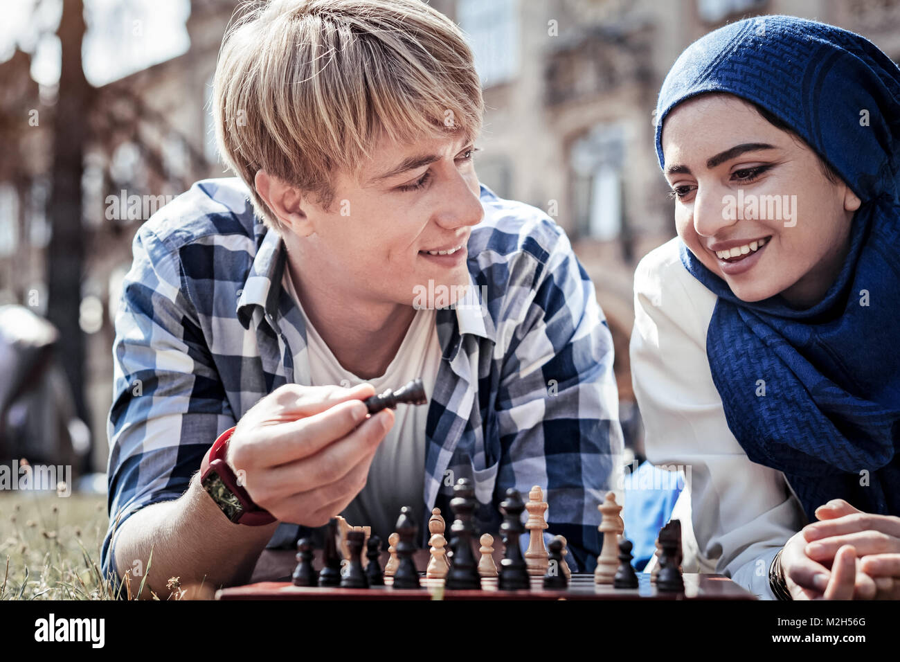 Handsome intelligent man holding a chess piece Stock Photo - Alamy