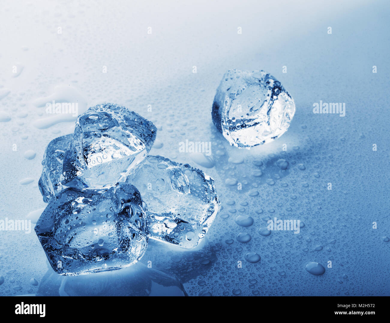 Frozen ice cubes on wet background with drops of water Stock Photo - Alamy
